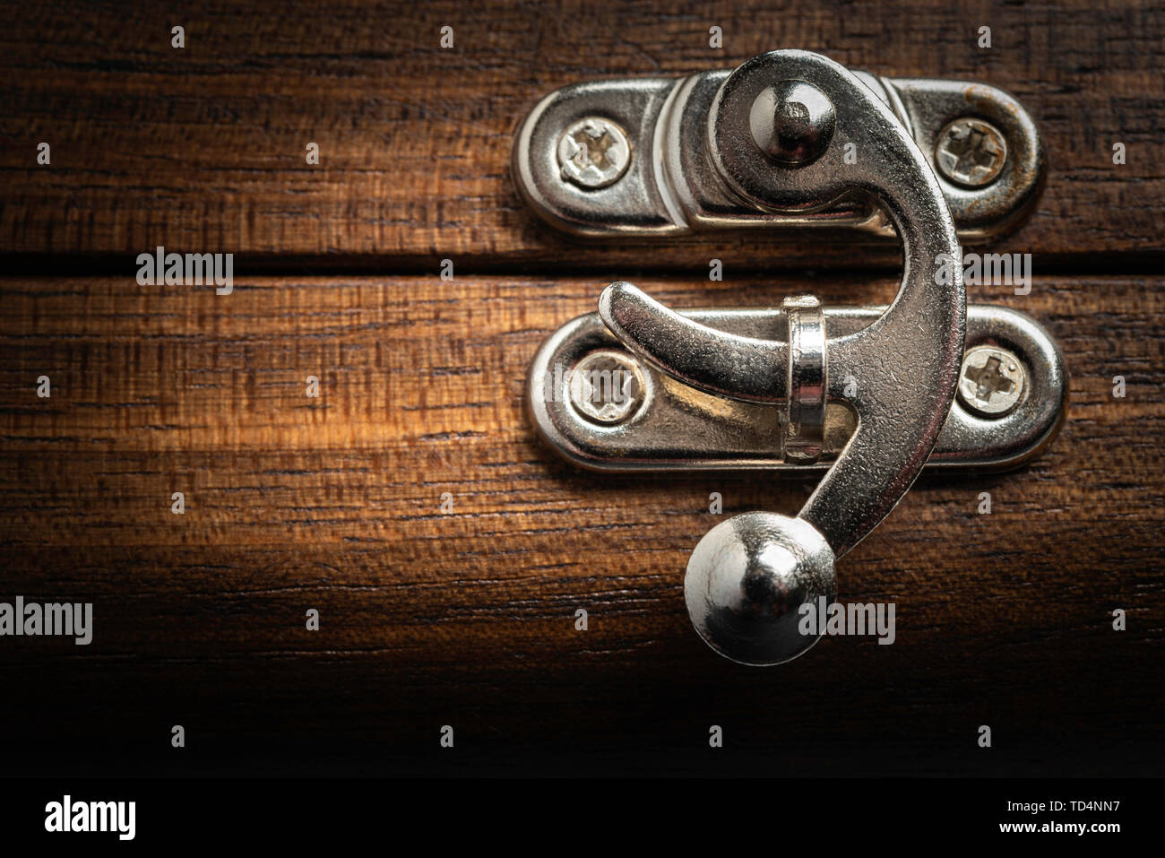 A close-up frontal view of a fancy silver-color sliding latch lock for ...