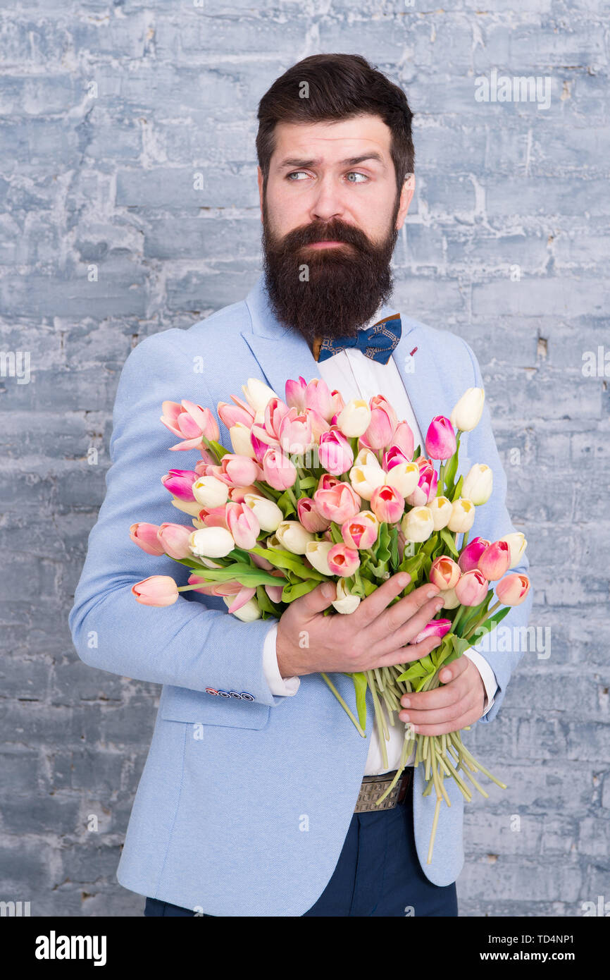 Flower for March 8. Bearded man with tulip flower bouquet. Love date ...