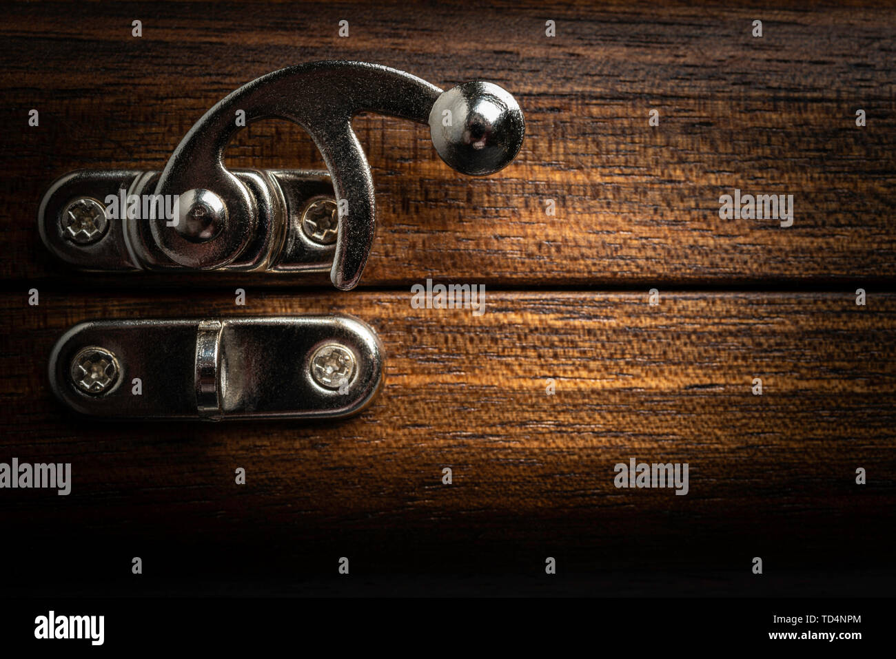 A close-up frontal view of a fancy silver-color sliding latch lock for ...