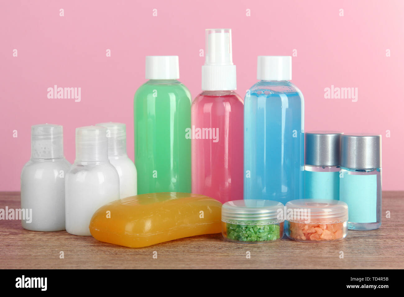 Hotel amenities kit on table on pink background Stock Photo - Alamy
