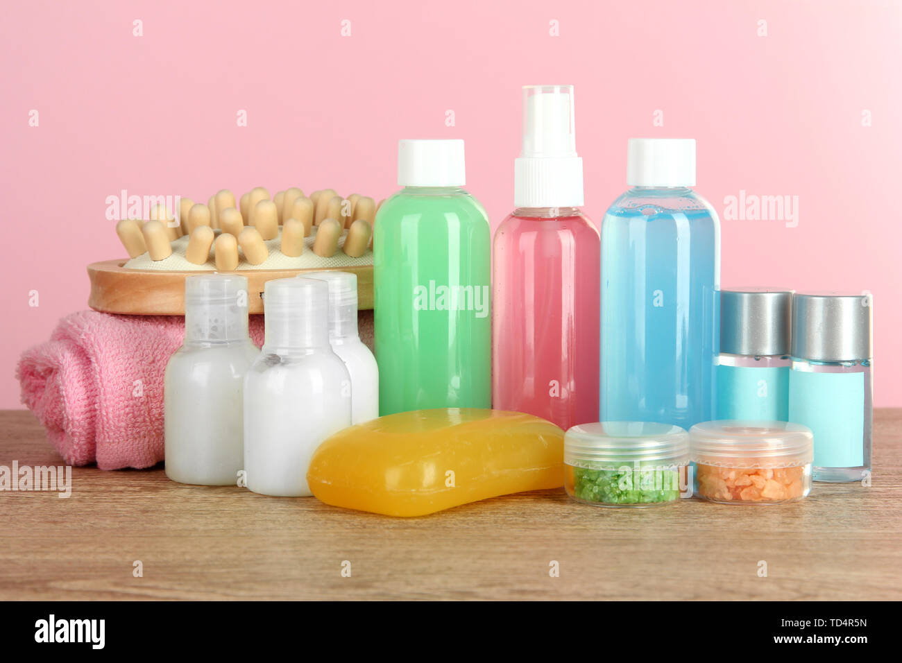 Hotel amenities kit on table on pink background Stock Photo - Alamy