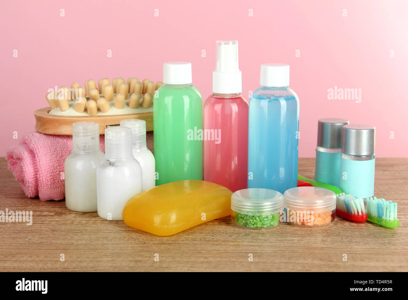 Hotel amenities kit on table on pink background Stock Photo - Alamy