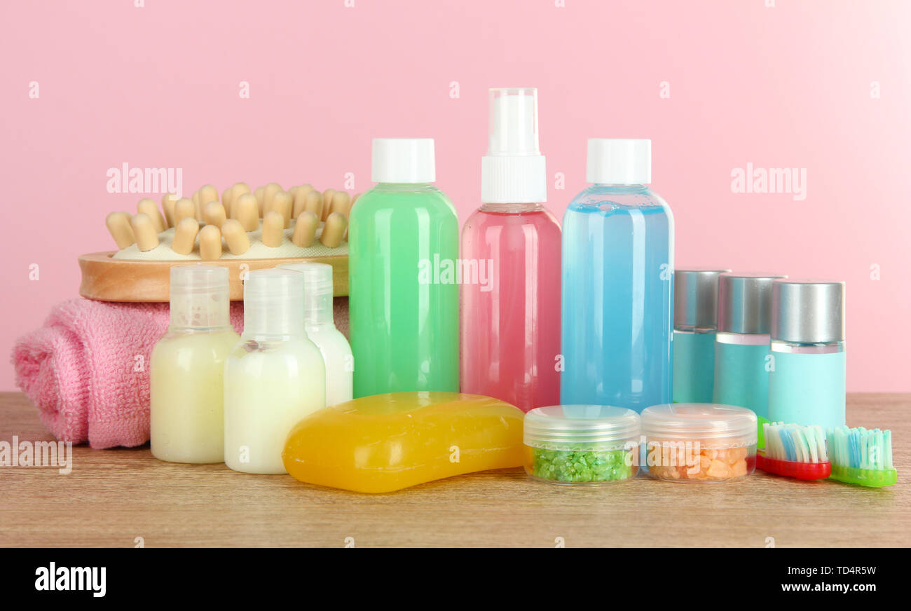 Hotel amenities kit on table on pink background Stock Photo - Alamy