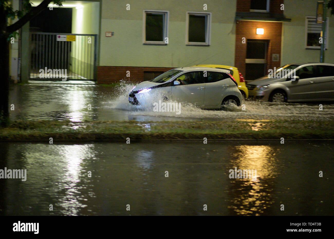 Berlin, Germany. 12th June, 2019. A car drives after a thunderstorm ...