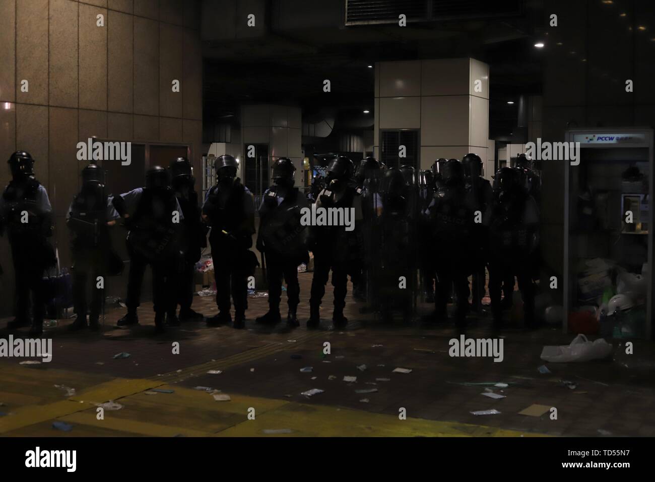 Hong Kong, China. 12th June, 2019. Riot police stand guard and block ...
