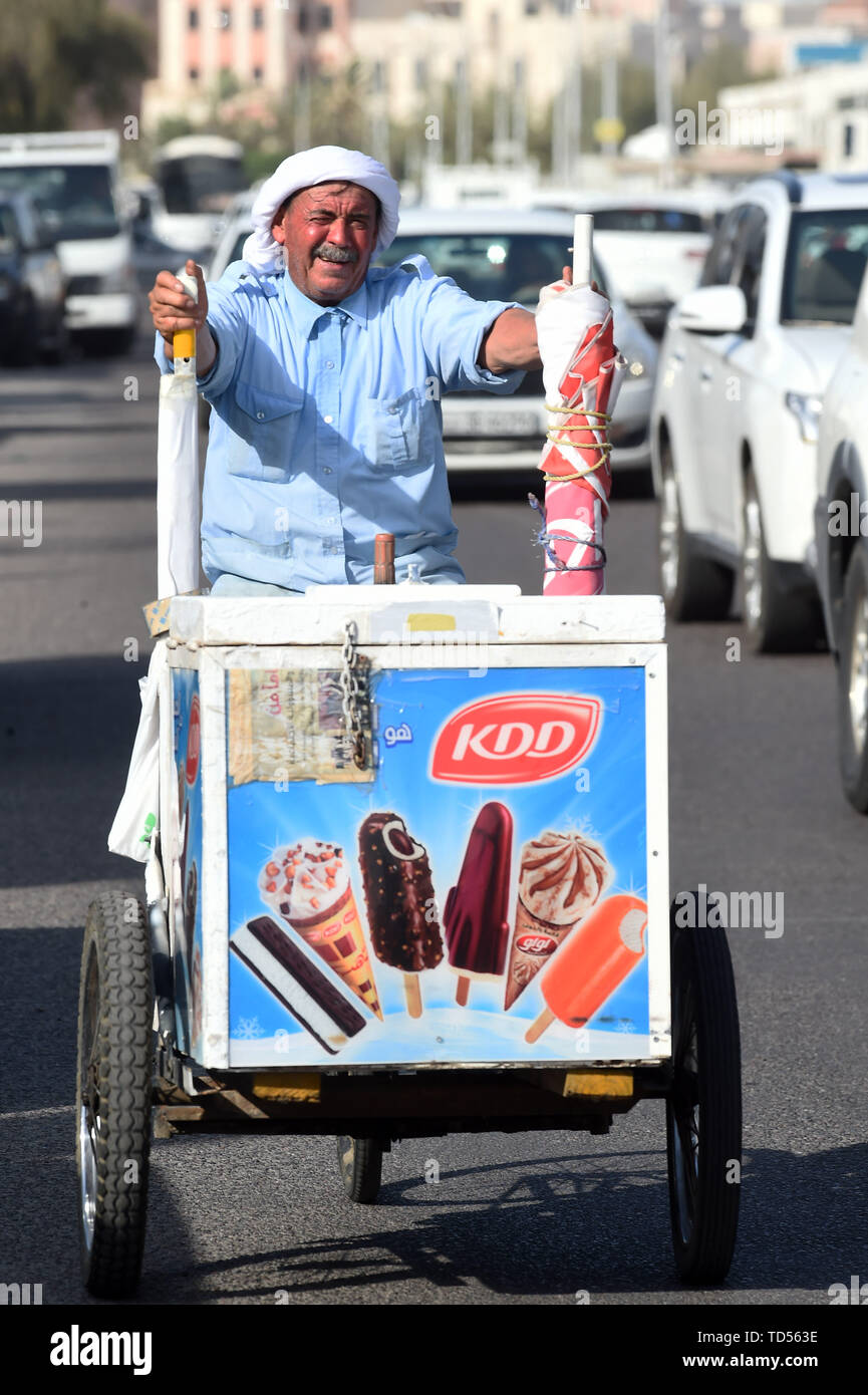 Kuwait City, Kuwait. 12th June, 2019. An ice cream vendor is seen on a ...