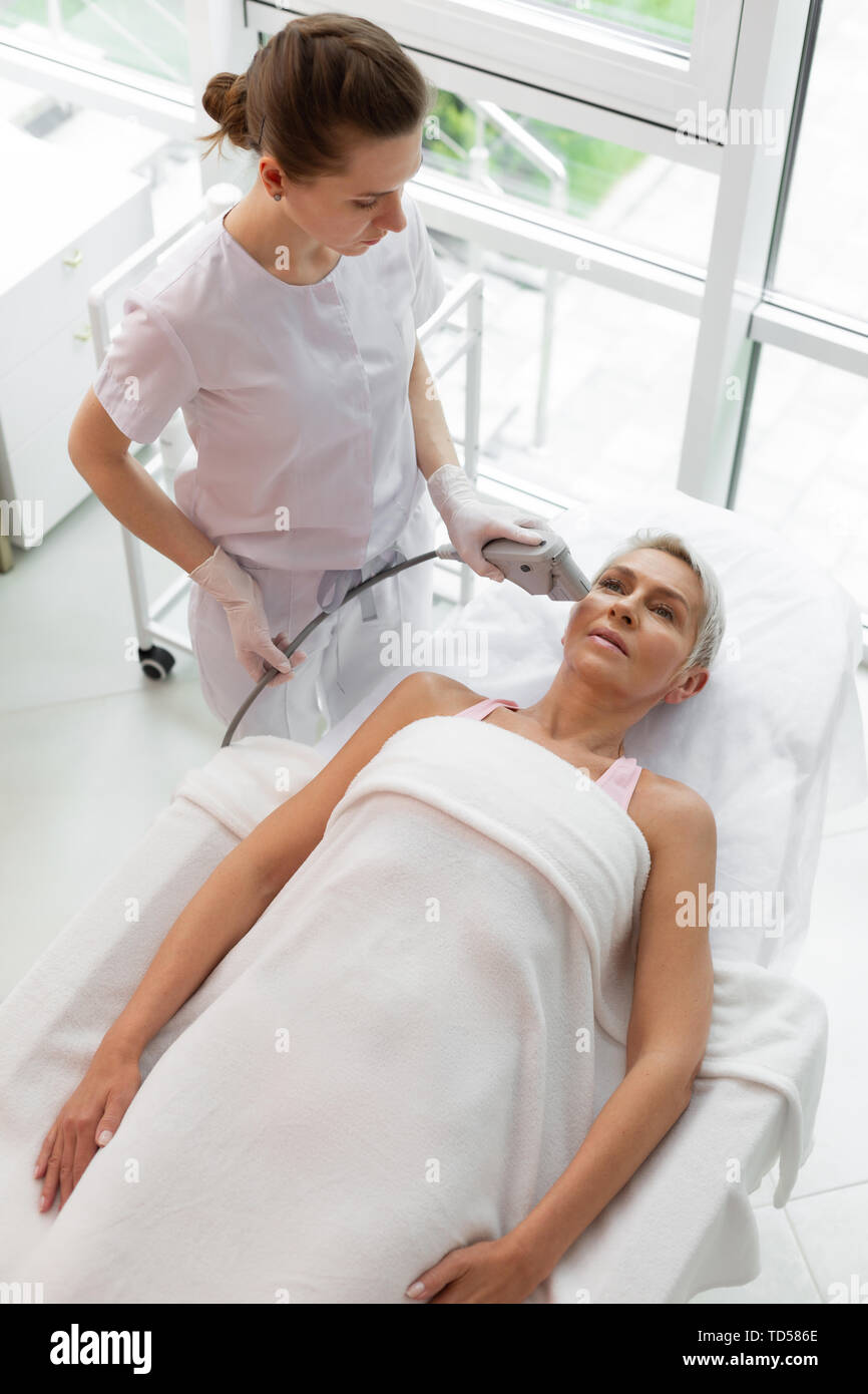 Professional treatment. Top view of a facial treatment procedure being ...