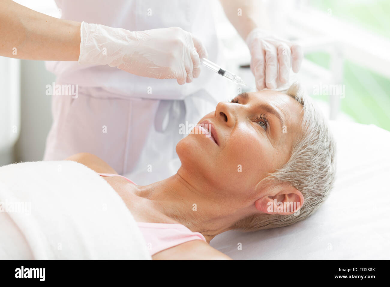 Perfect face. Nice good looking woman lying on the medical bed while ...