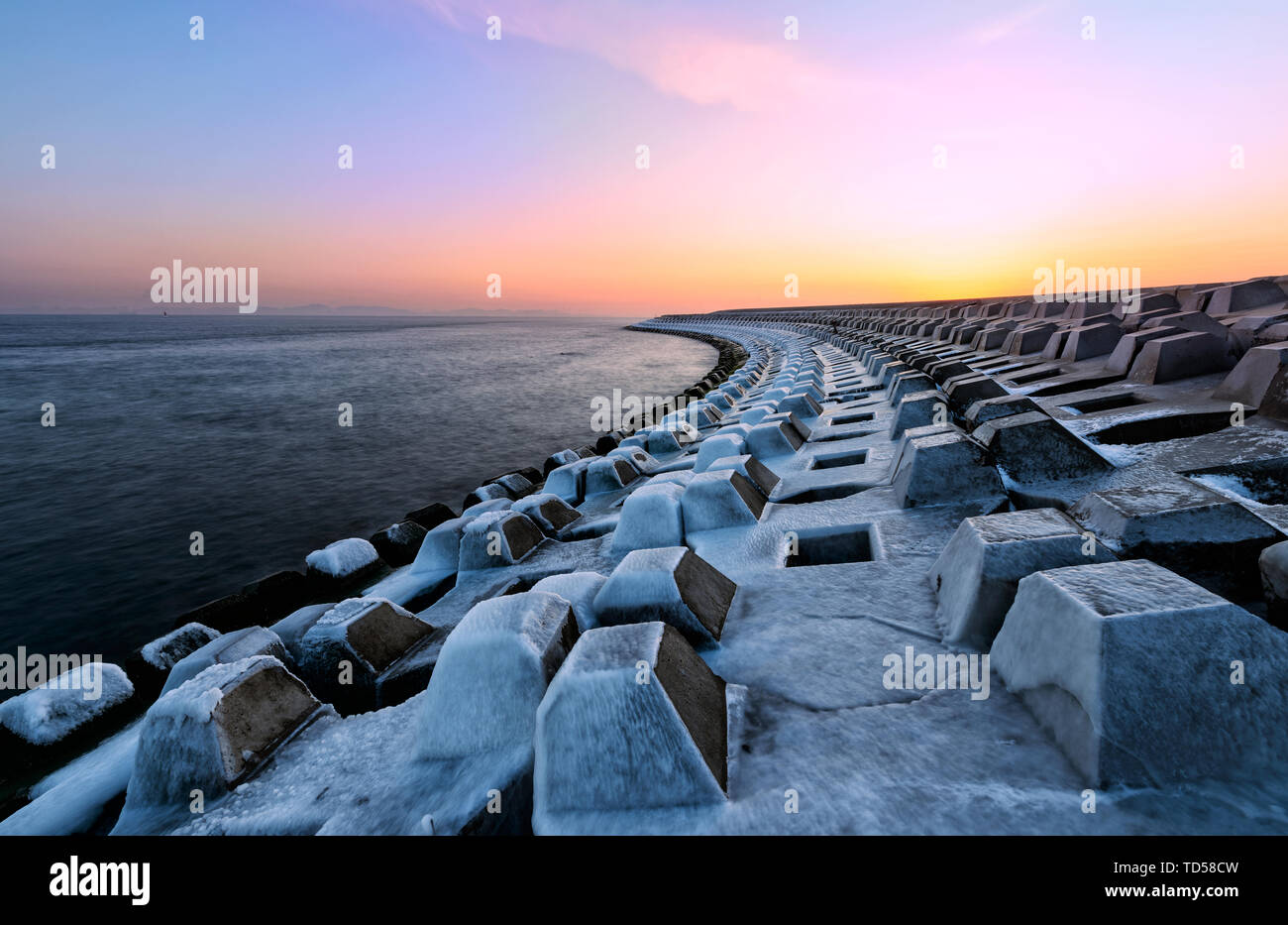 Morning glow, frozen seawall Stock Photo - Alamy