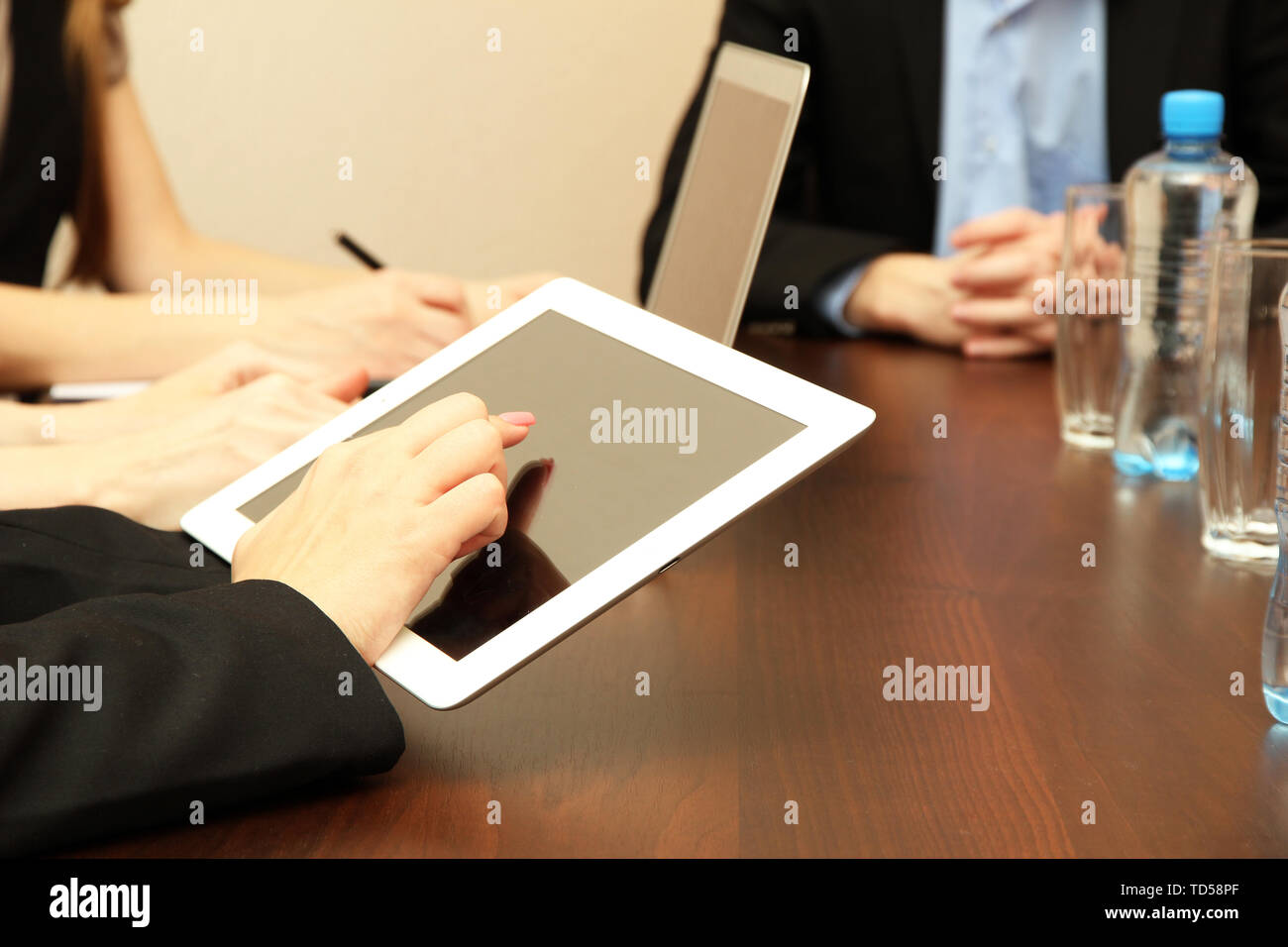 Female hands with digital tablet on office background Stock Photo - Alamy