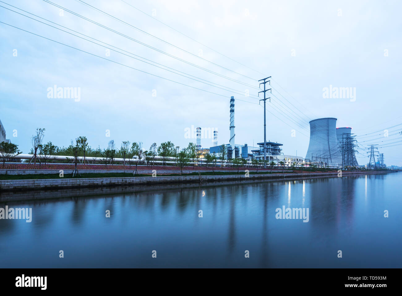 modern power station near water in twilight Stock Photo - Alamy