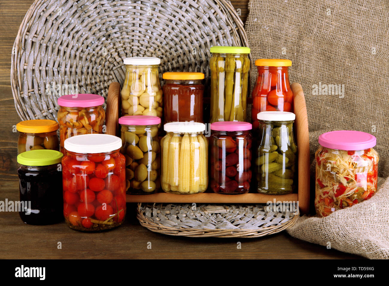 Different conservations on shelves on wooden background Stock Photo - Alamy