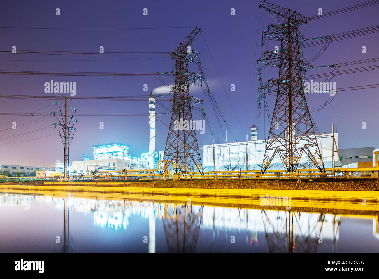 buildings of modern power station near river at twilight Stock Photo ...