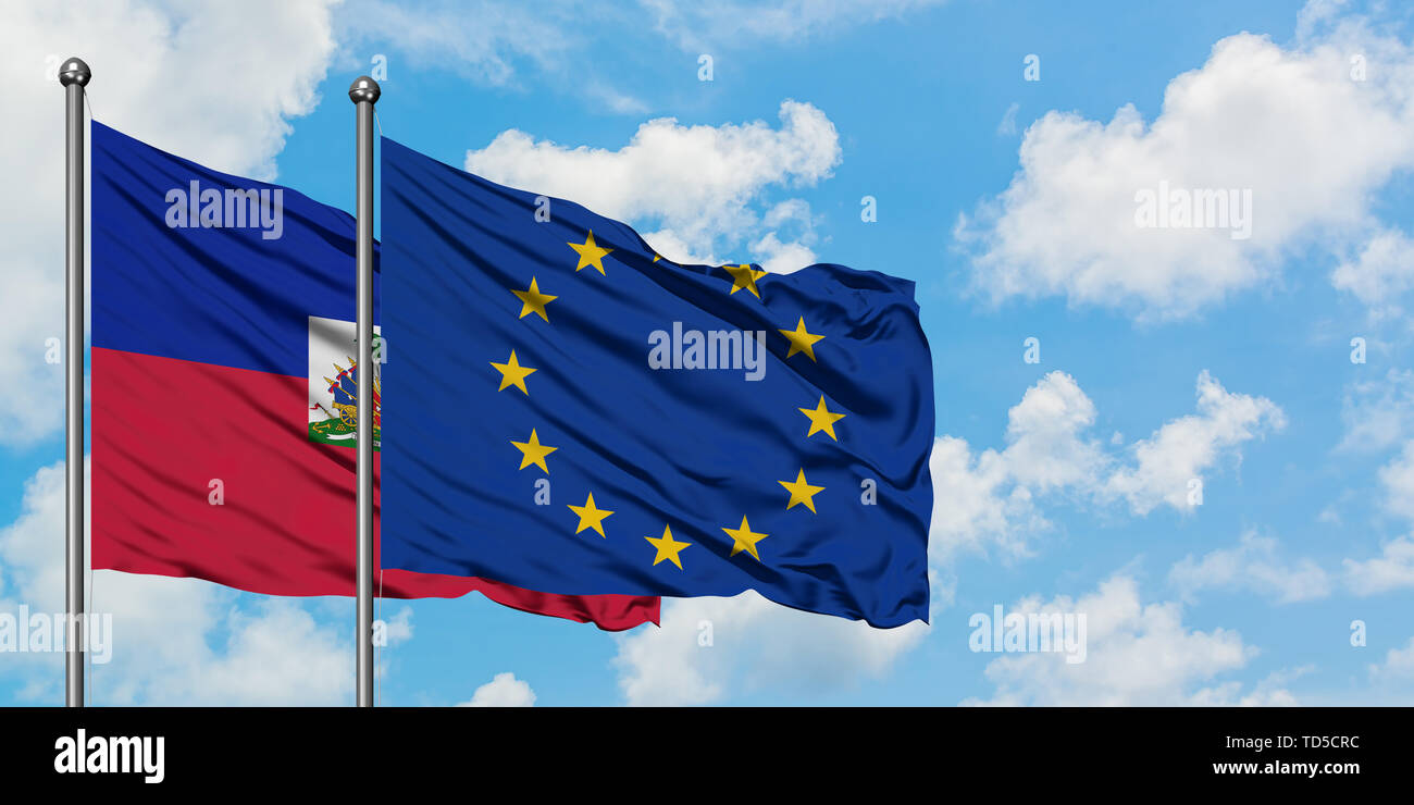 Haiti and European Union flag waving in the wind against white cloudy ...