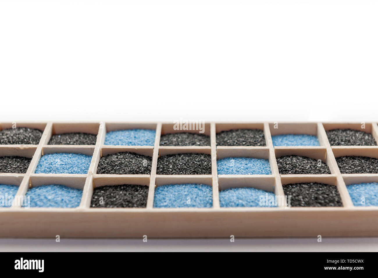 Low angle view of a rectangular wooden box with square compartments ...