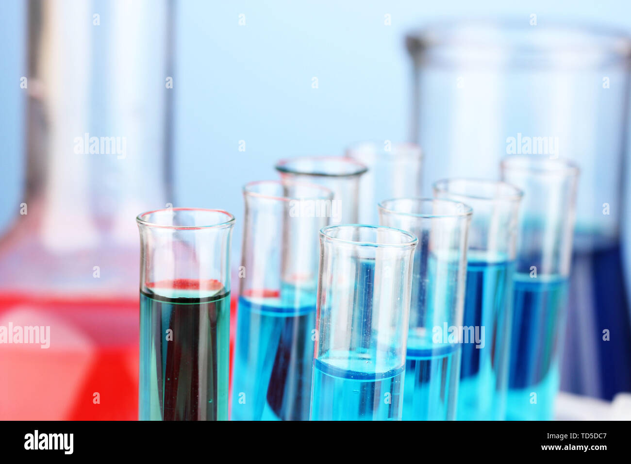 Test-tubes on color background Stock Photo - Alamy