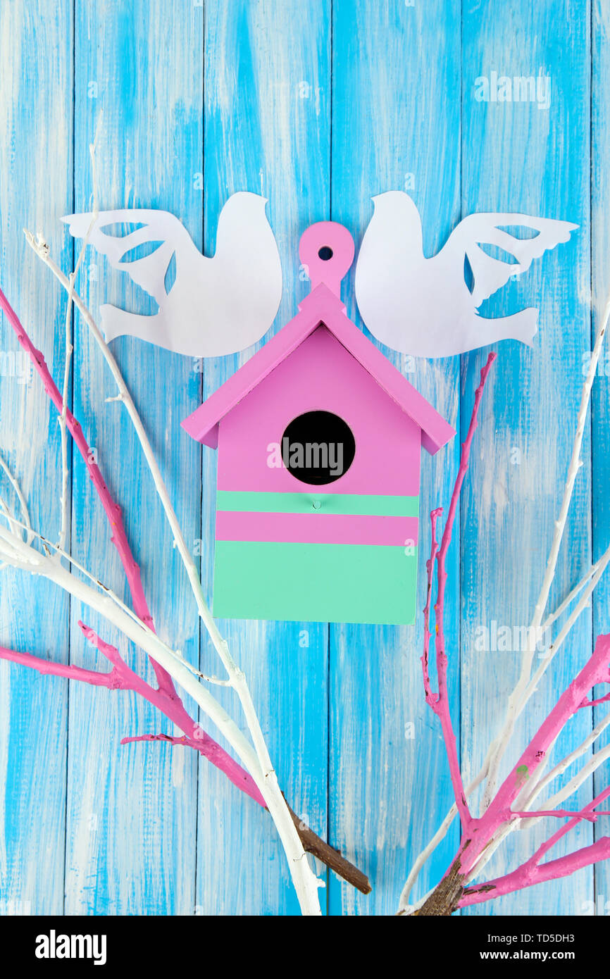 Decorative nesting box with paper birds and color branches, on color ...