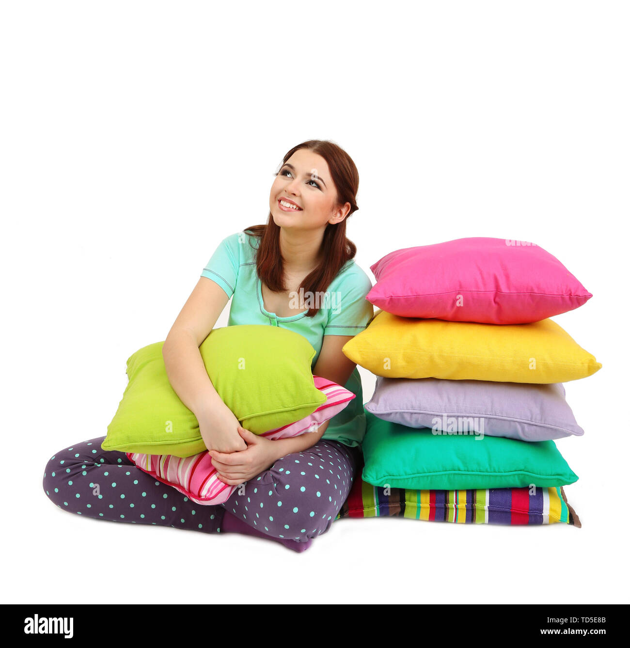 Beautiful young girl with pillows isolated on white Stock Photo - Alamy