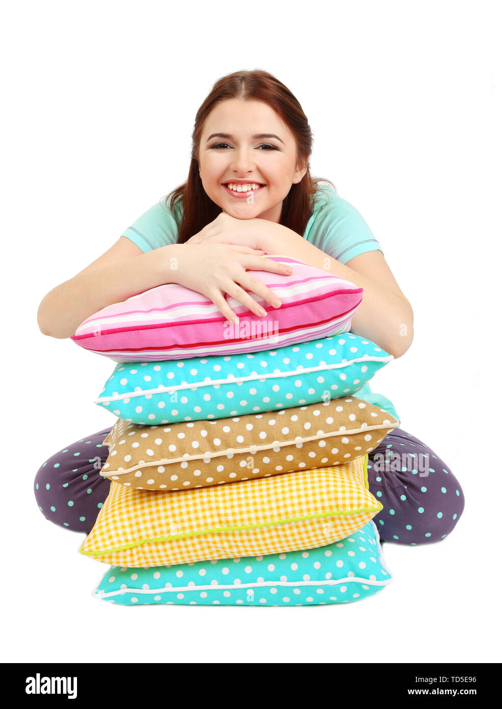 Beautiful young girl with pillows isolated on white Stock Photo - Alamy