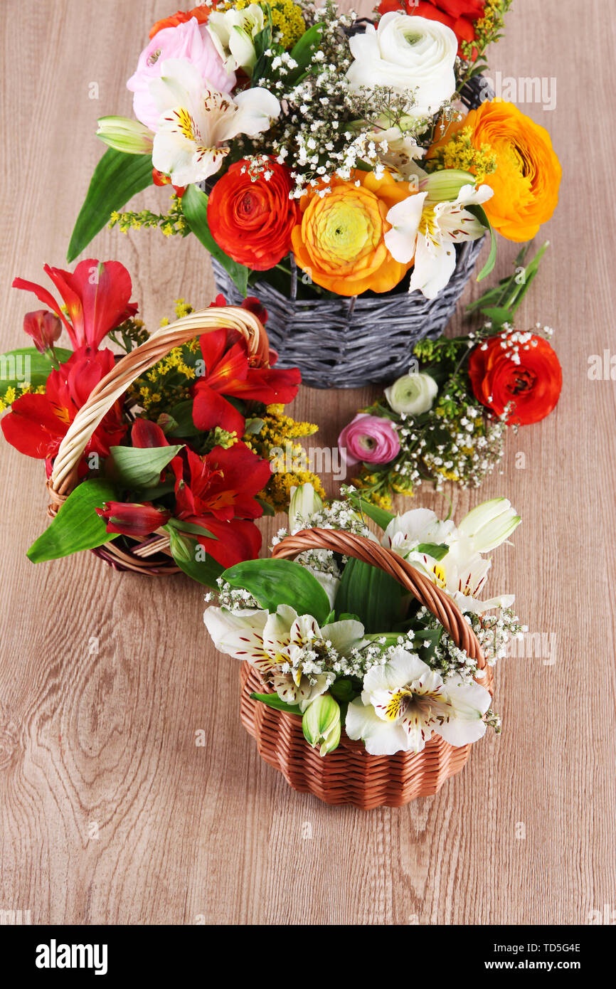 Many different flowers in baskets on light background Stock Photo - Alamy
