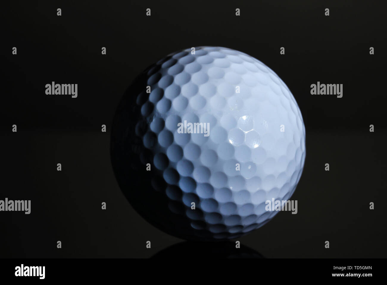 Golf ball on grey background Stock Photo - Alamy