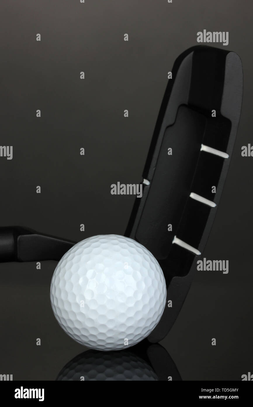 Golf ball and driver on grey background Stock Photo - Alamy