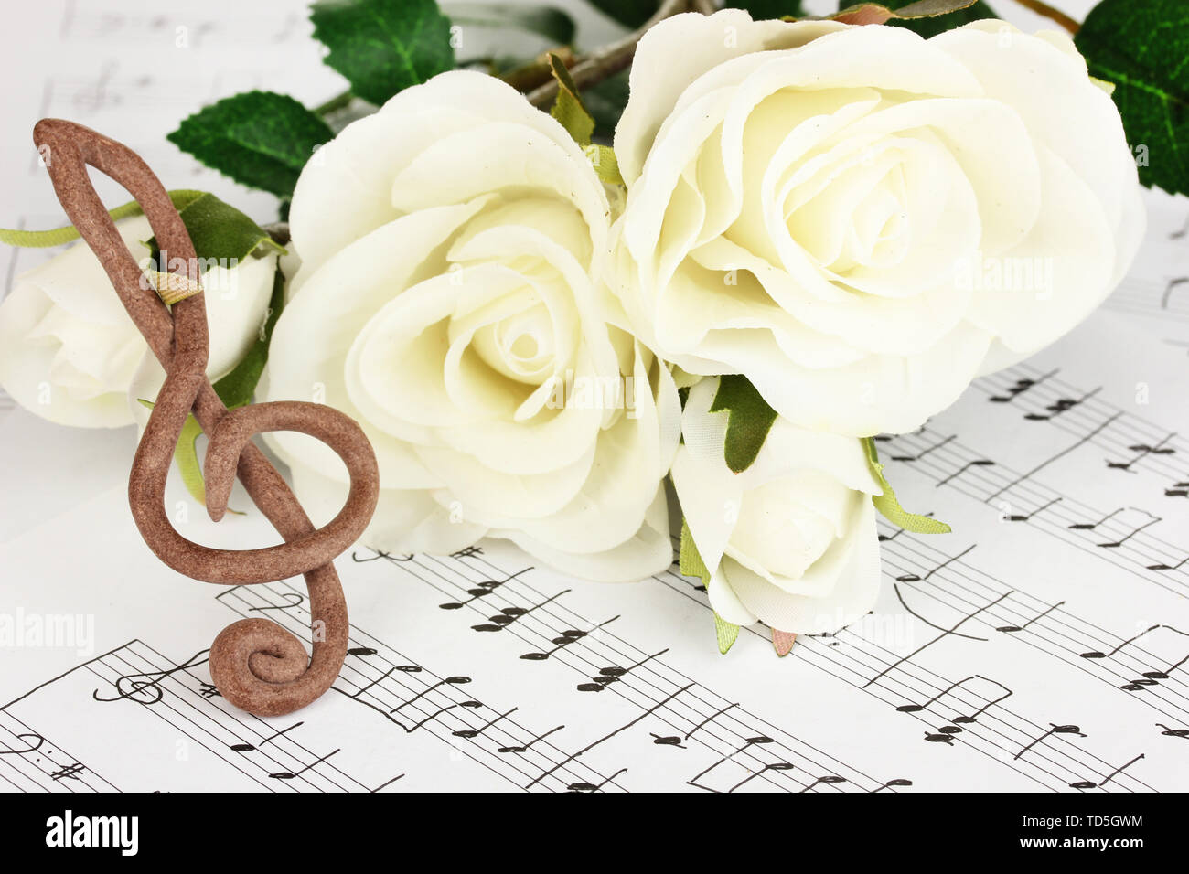 Treble clef and roses on musical background Stock Photo - Alamy