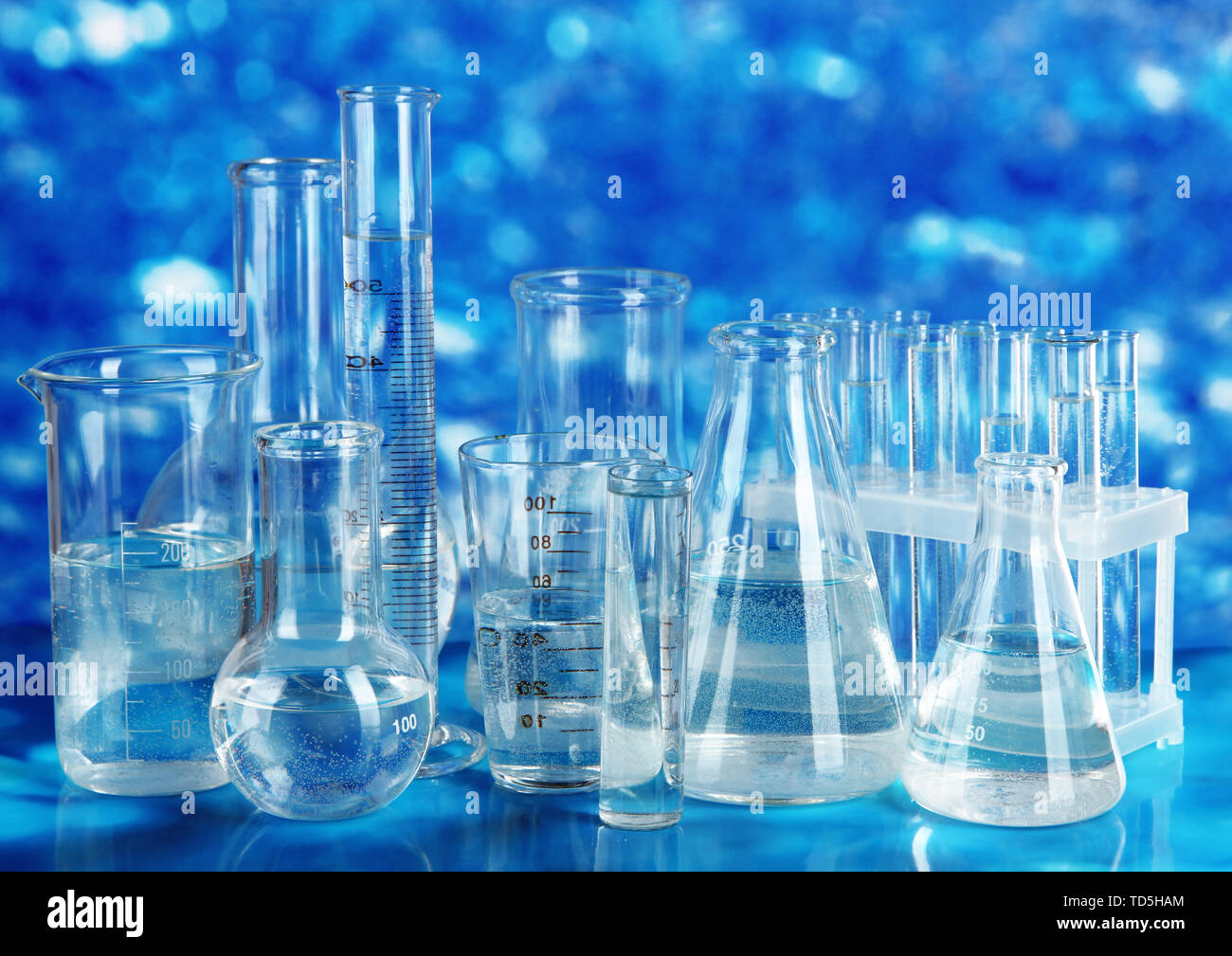 Test tubes on blue background Stock Photo - Alamy