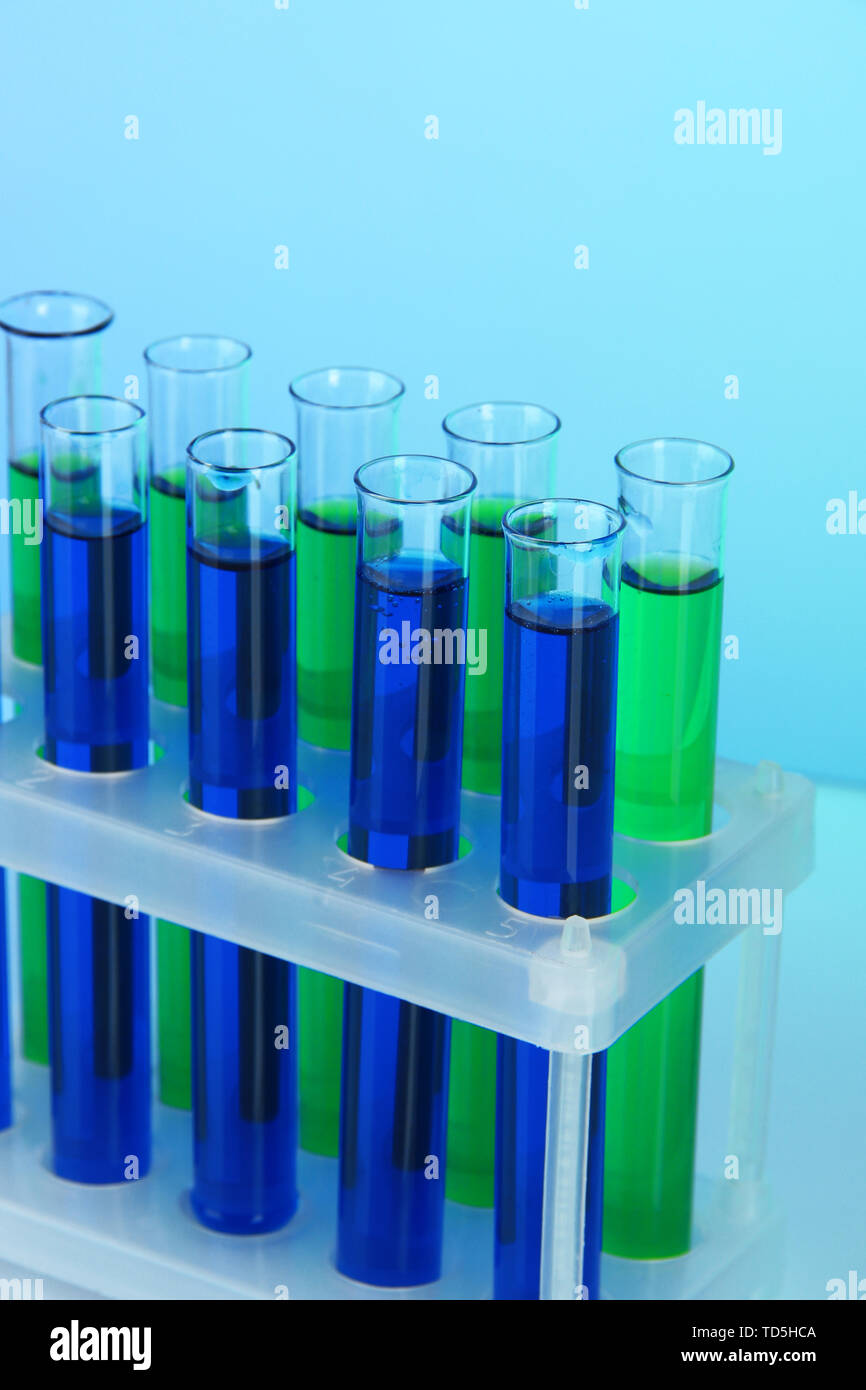 Identical test tubes on blue background Stock Photo - Alamy