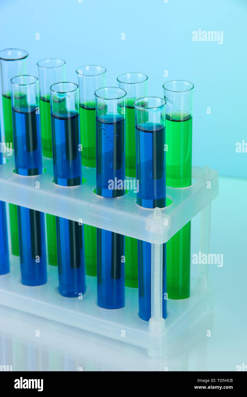 Identical test tubes on blue background Stock Photo - Alamy