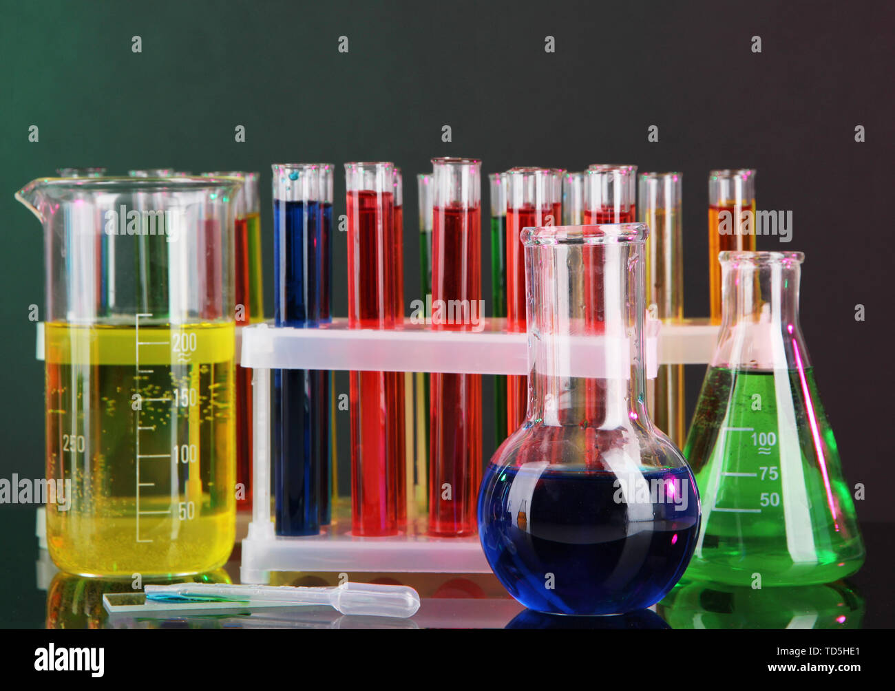 Colorful test tubes on dark background Stock Photo - Alamy