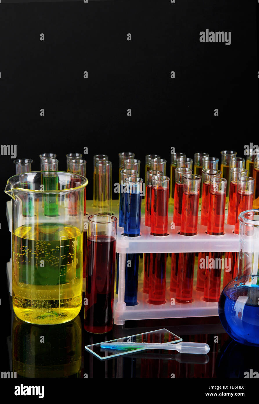 Colorful test tubes on dark background Stock Photo - Alamy