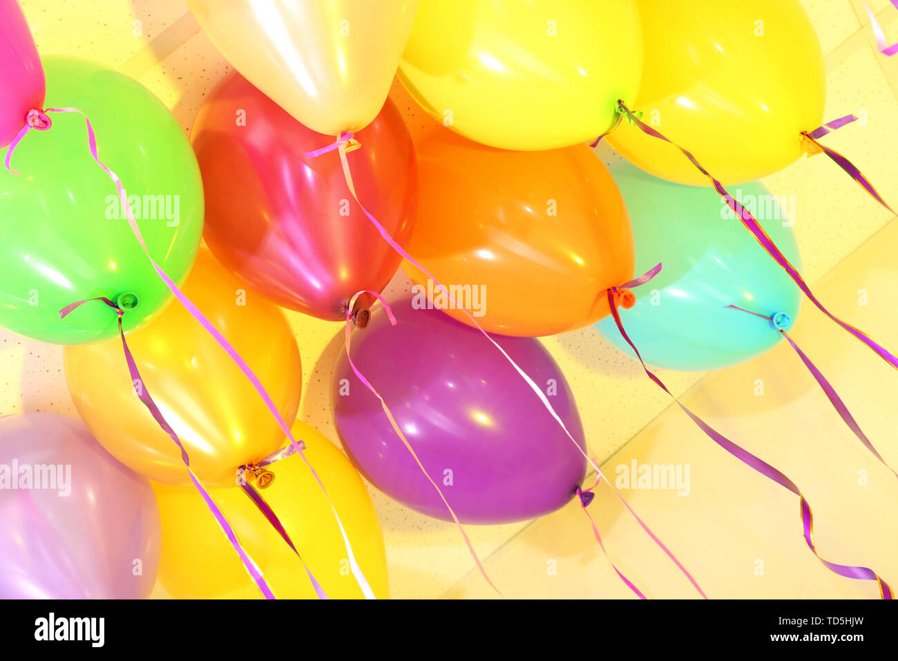 Many bright balloons under ceiling close-up Stock Photo - Alamy