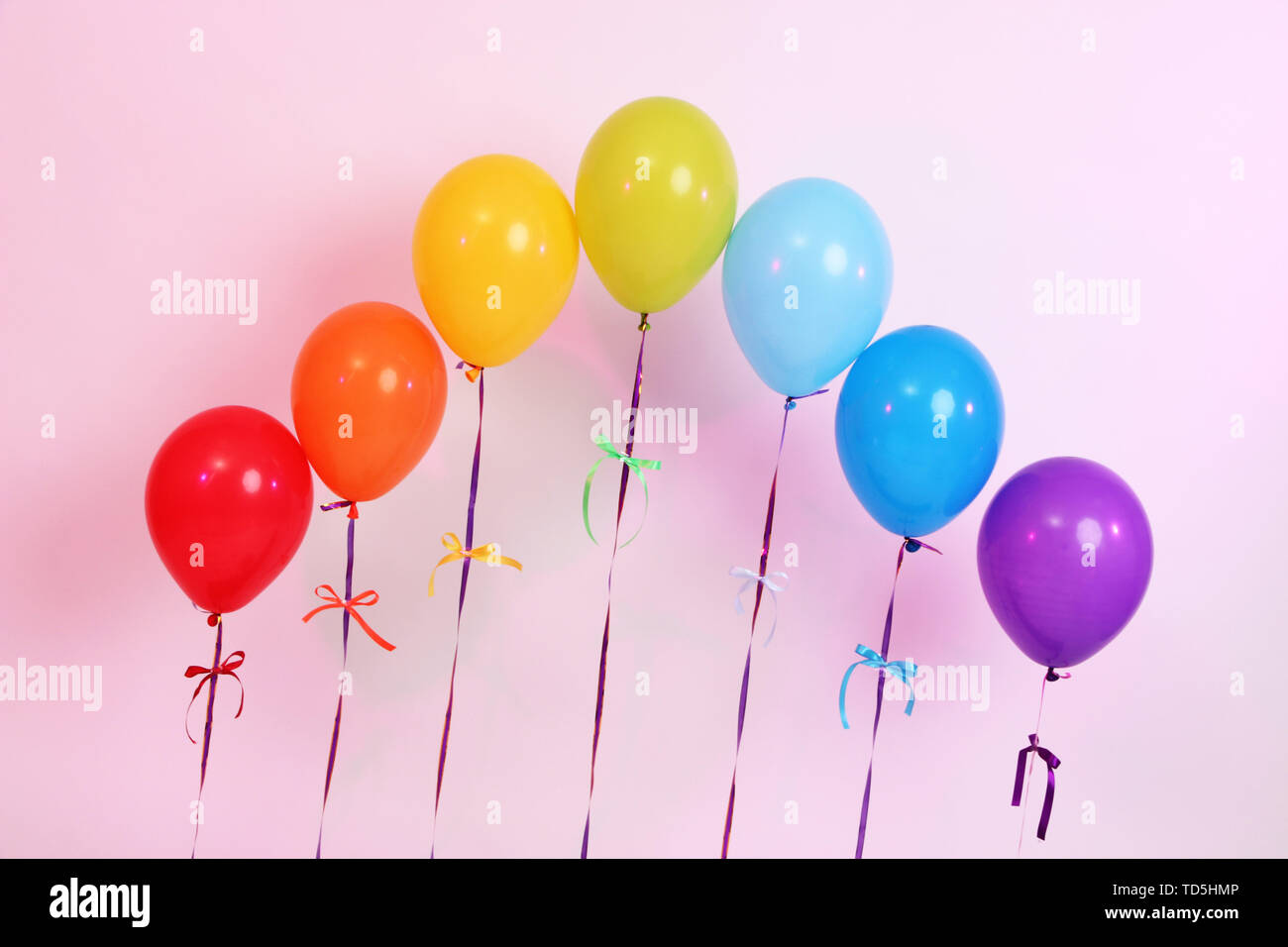 Rainbow of balloons on light background Stock Photo - Alamy