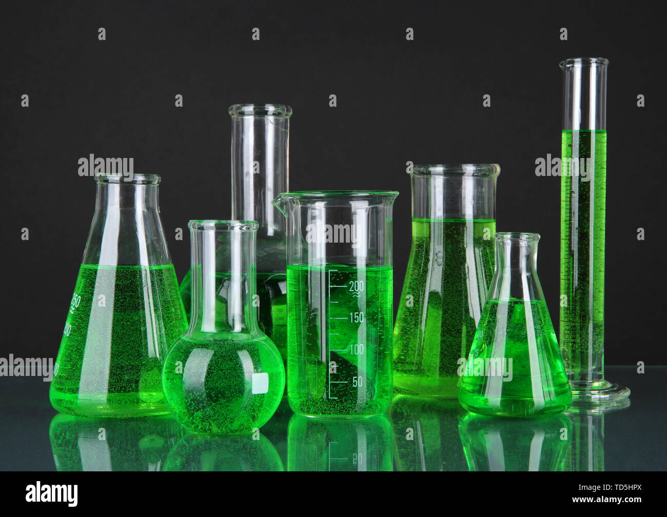 Test-tubes with green liquid on dark gray background Stock Photo - Alamy