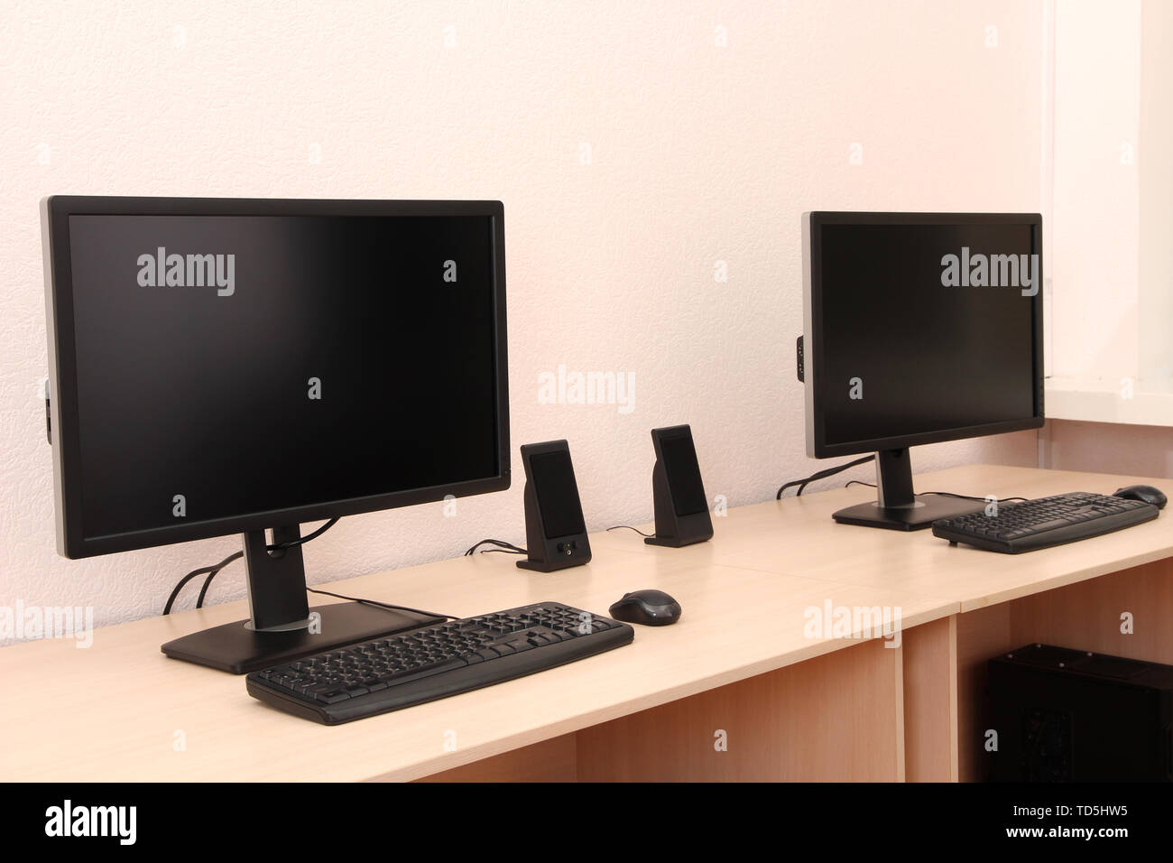 Computers on tables in room Stock Photo - Alamy