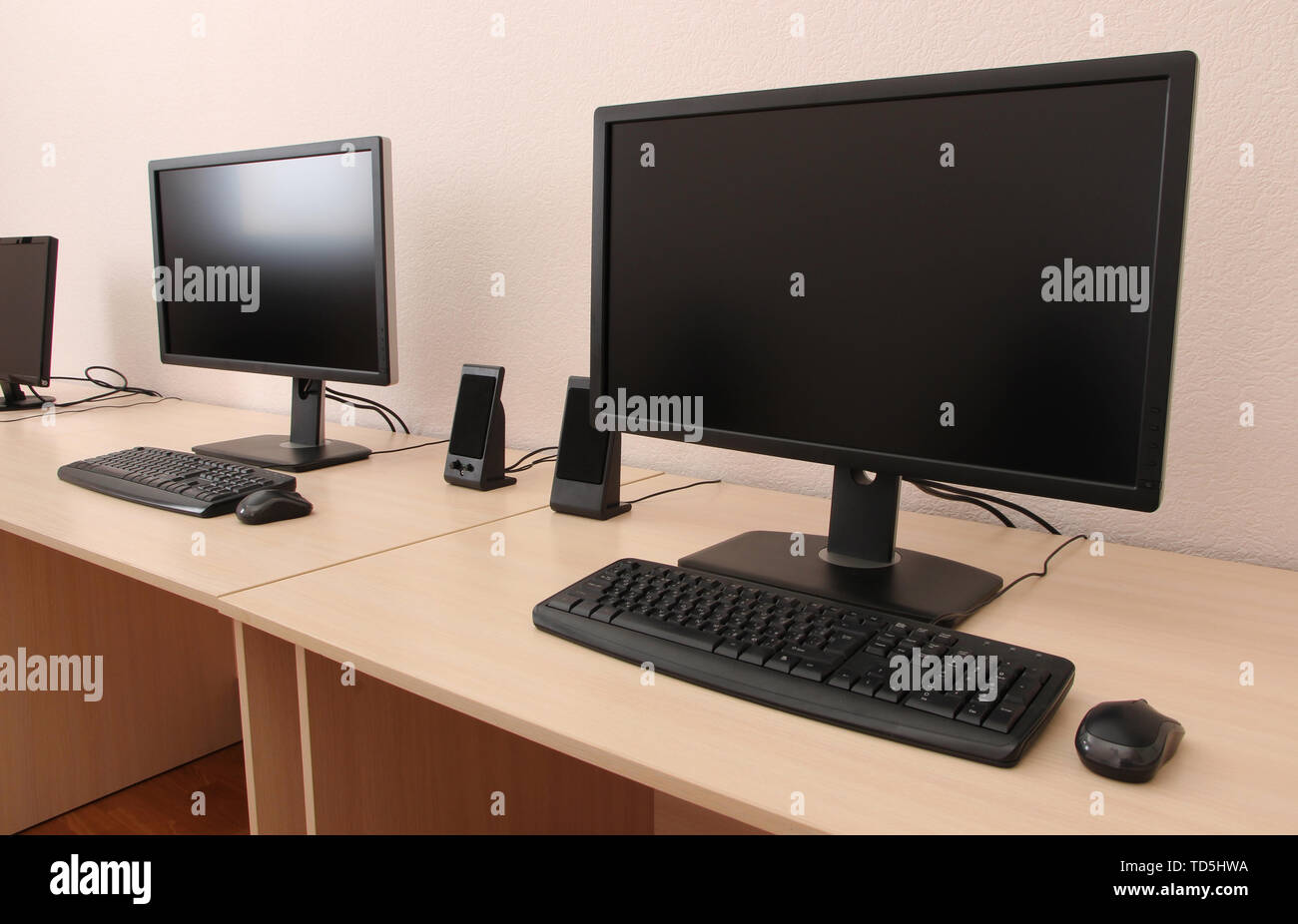 Computers on tables in room Stock Photo - Alamy