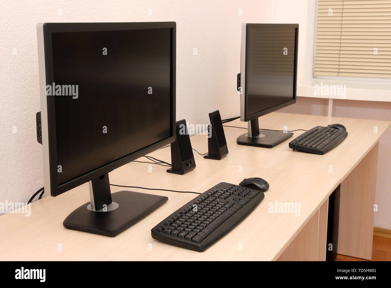 Computers on tables in room Stock Photo - Alamy