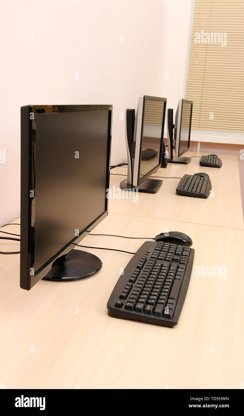 Computers on tables in room Stock Photo - Alamy