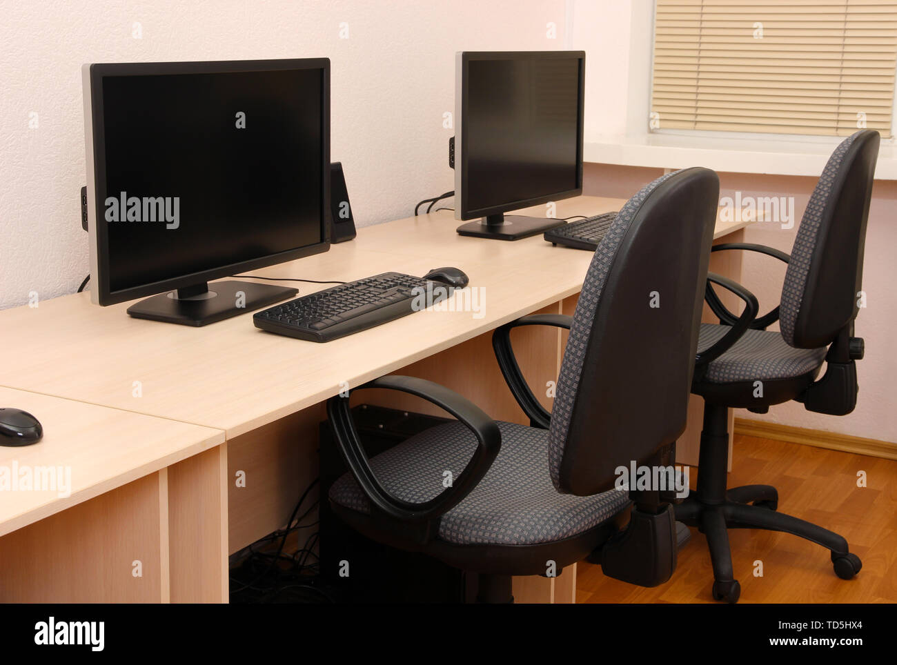 Computers on tables in room Stock Photo - Alamy