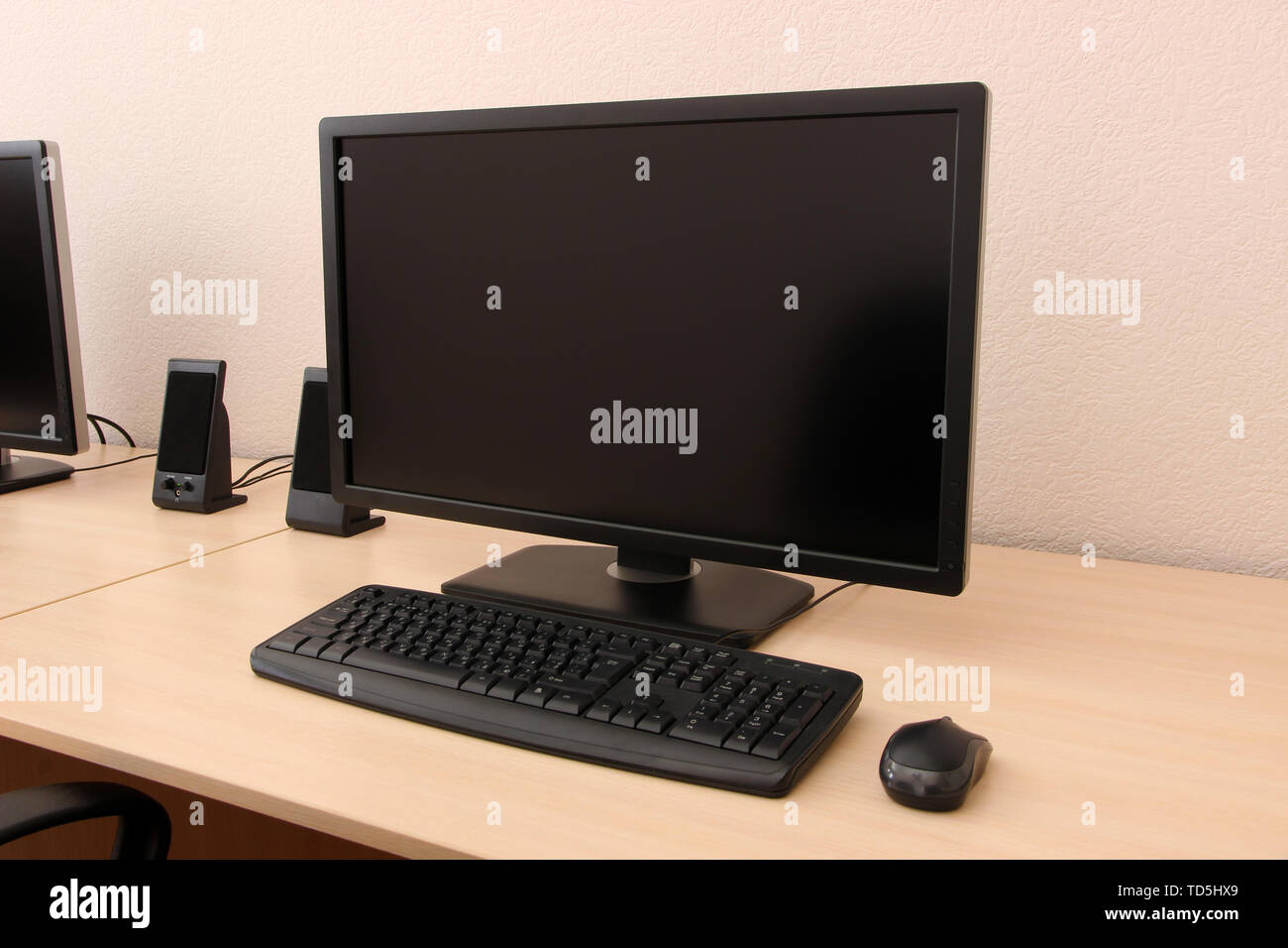 Computer on table in room Stock Photo - Alamy
