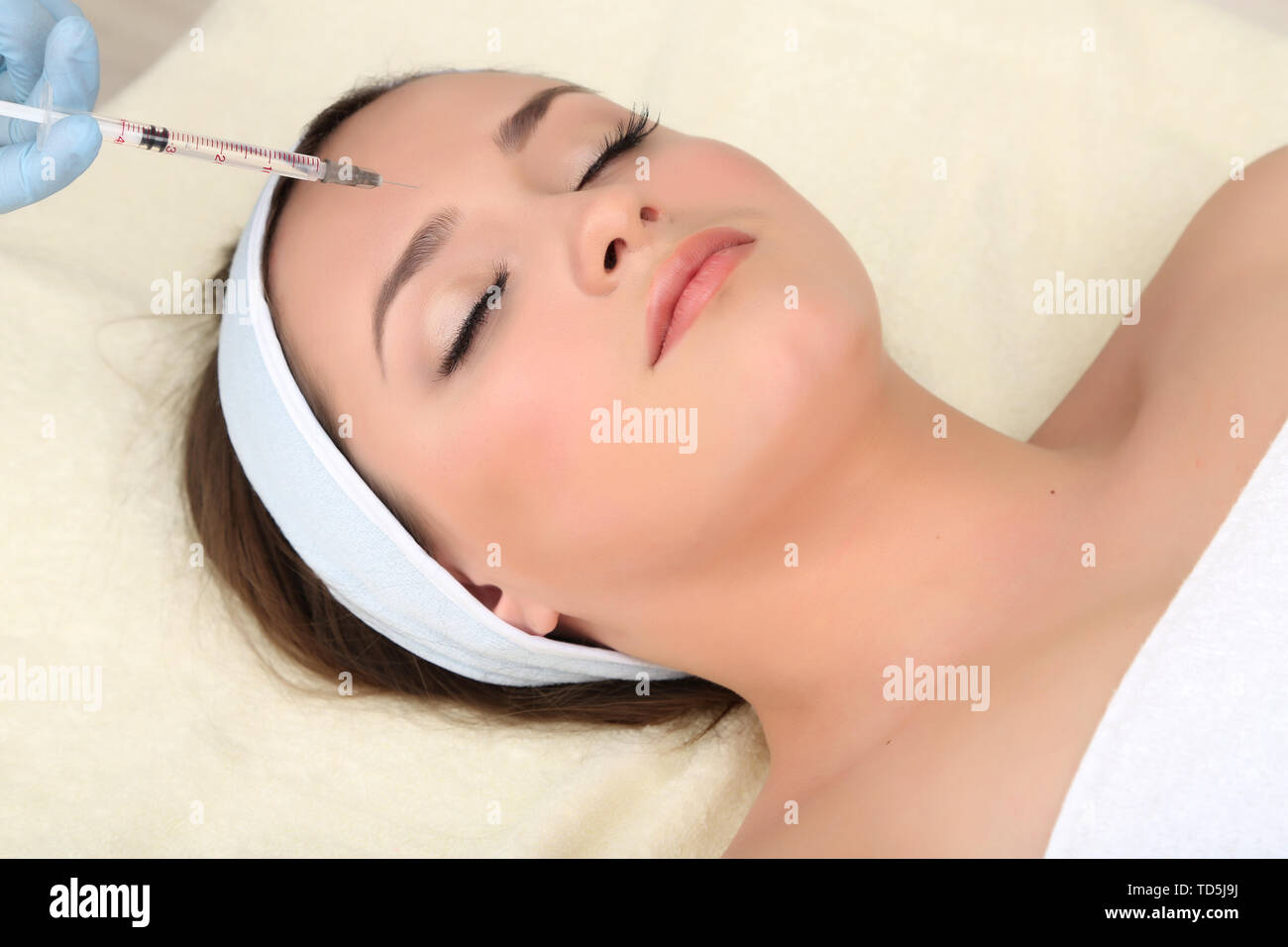 Young woman receiving plastic surgery injection on her face close up ...