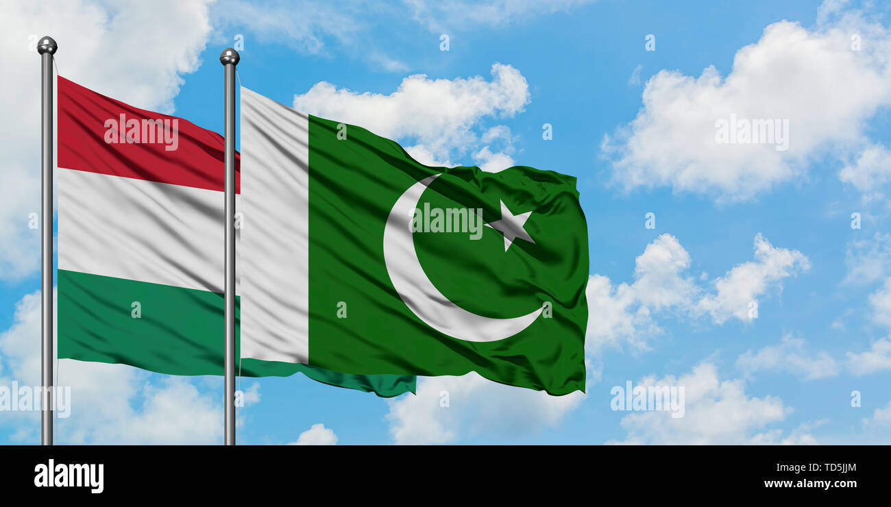Hungary and Pakistan flag waving in the wind against white cloudy blue ...
