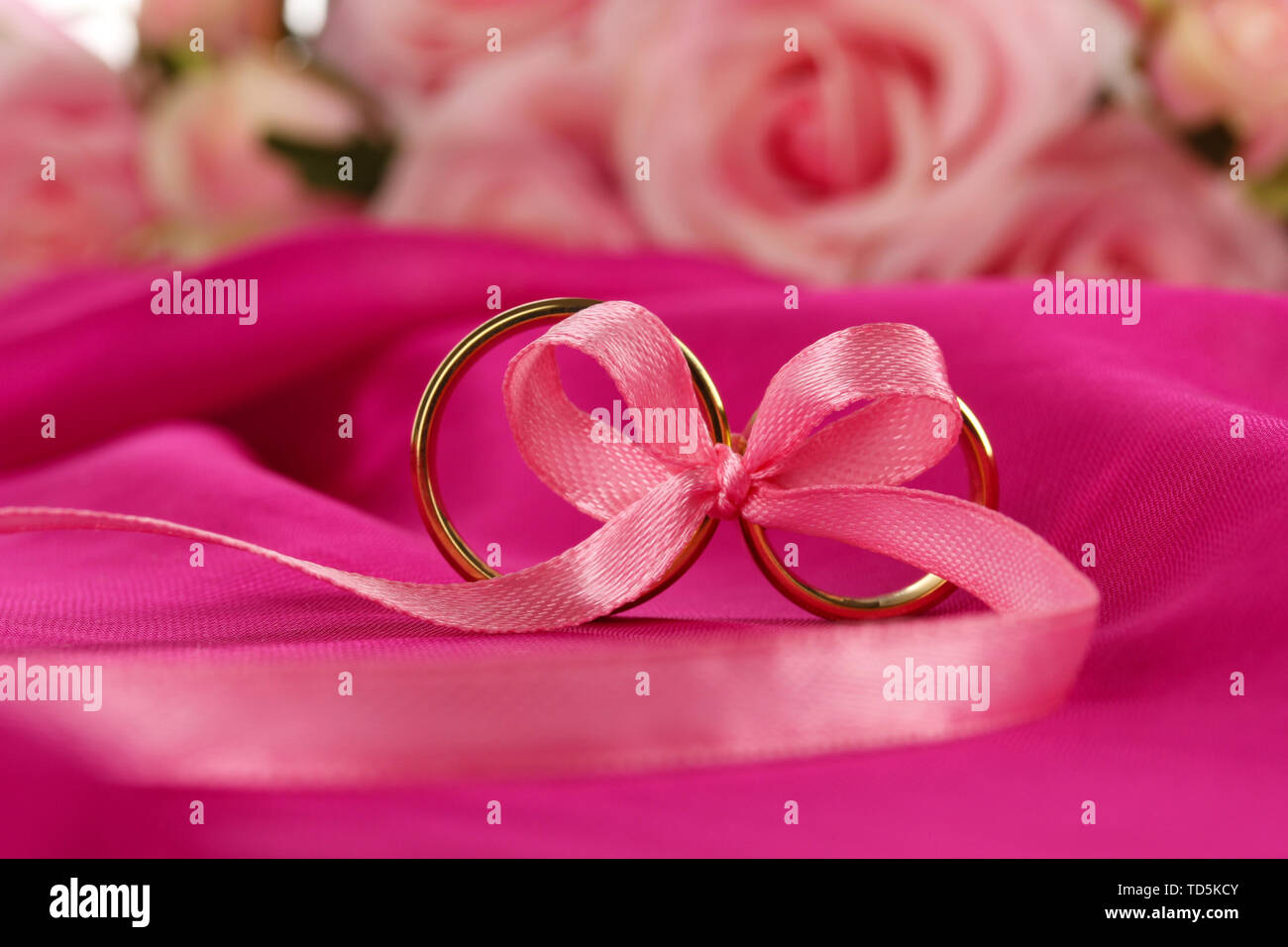 Wedding rings tied with ribbon Stock Photo - Alamy