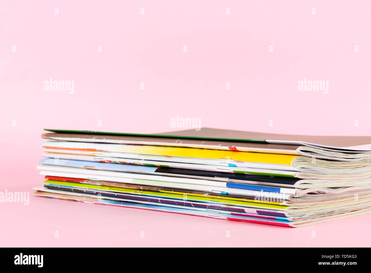 Many magazines on pink background Stock Photo - Alamy