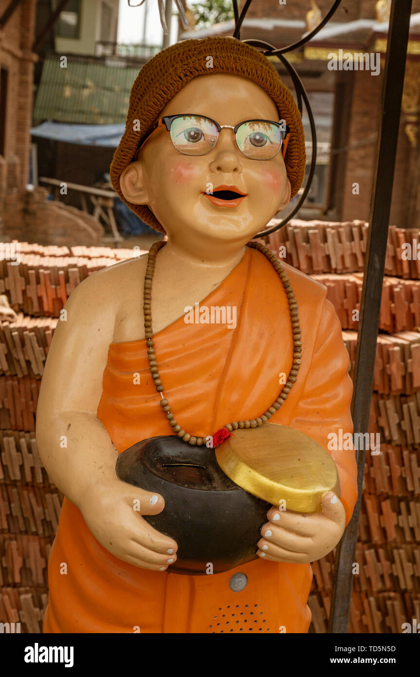 Plaster Statues of Young Student Monk Welcome You Stock Photo - Alamy