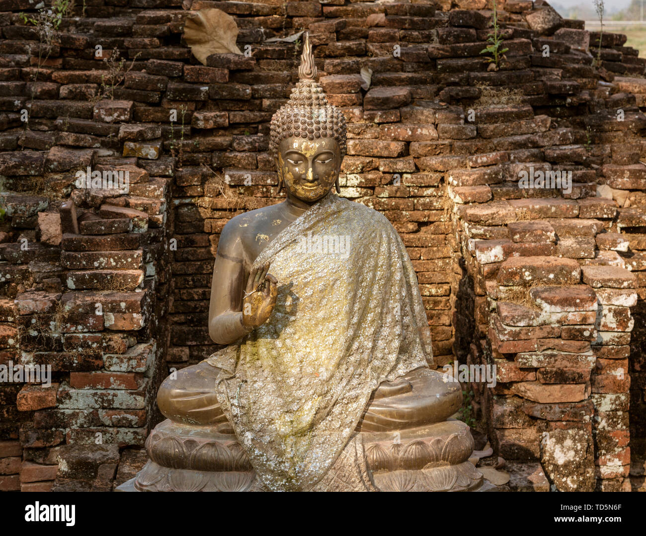 Sitting Stone Buddha in an Ancient Brick Alcove Stock Photo - Alamy