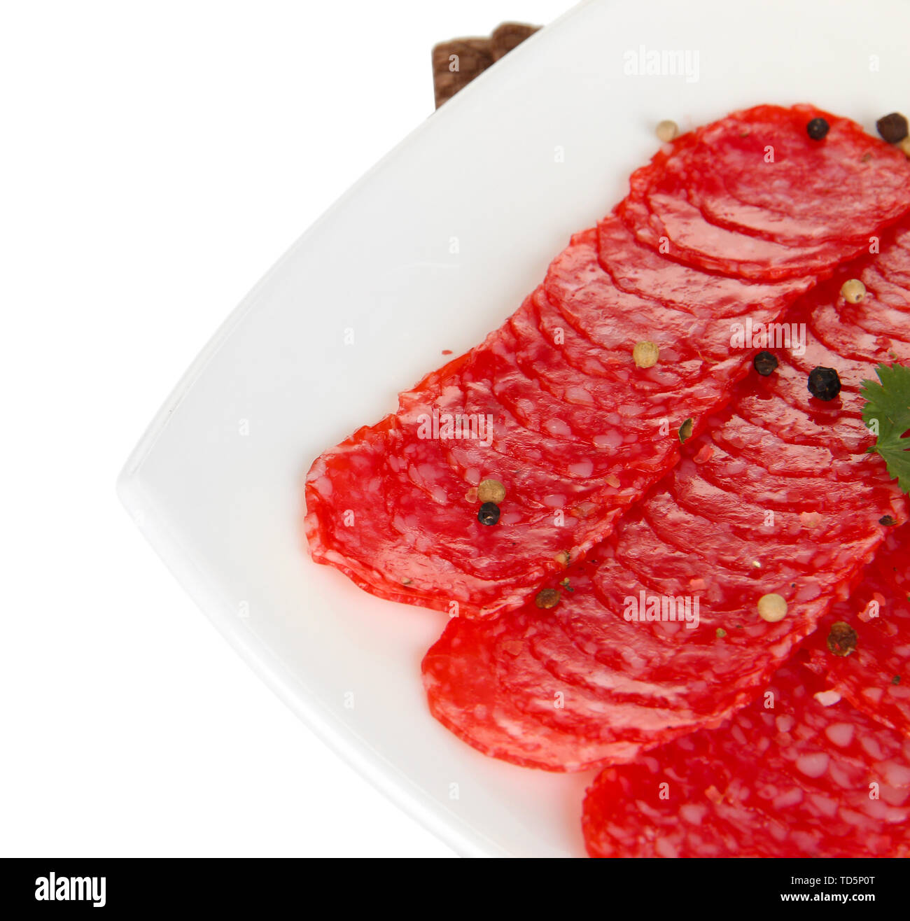 Tasty salami on plate on napkin isolated on white Stock Photo - Alamy