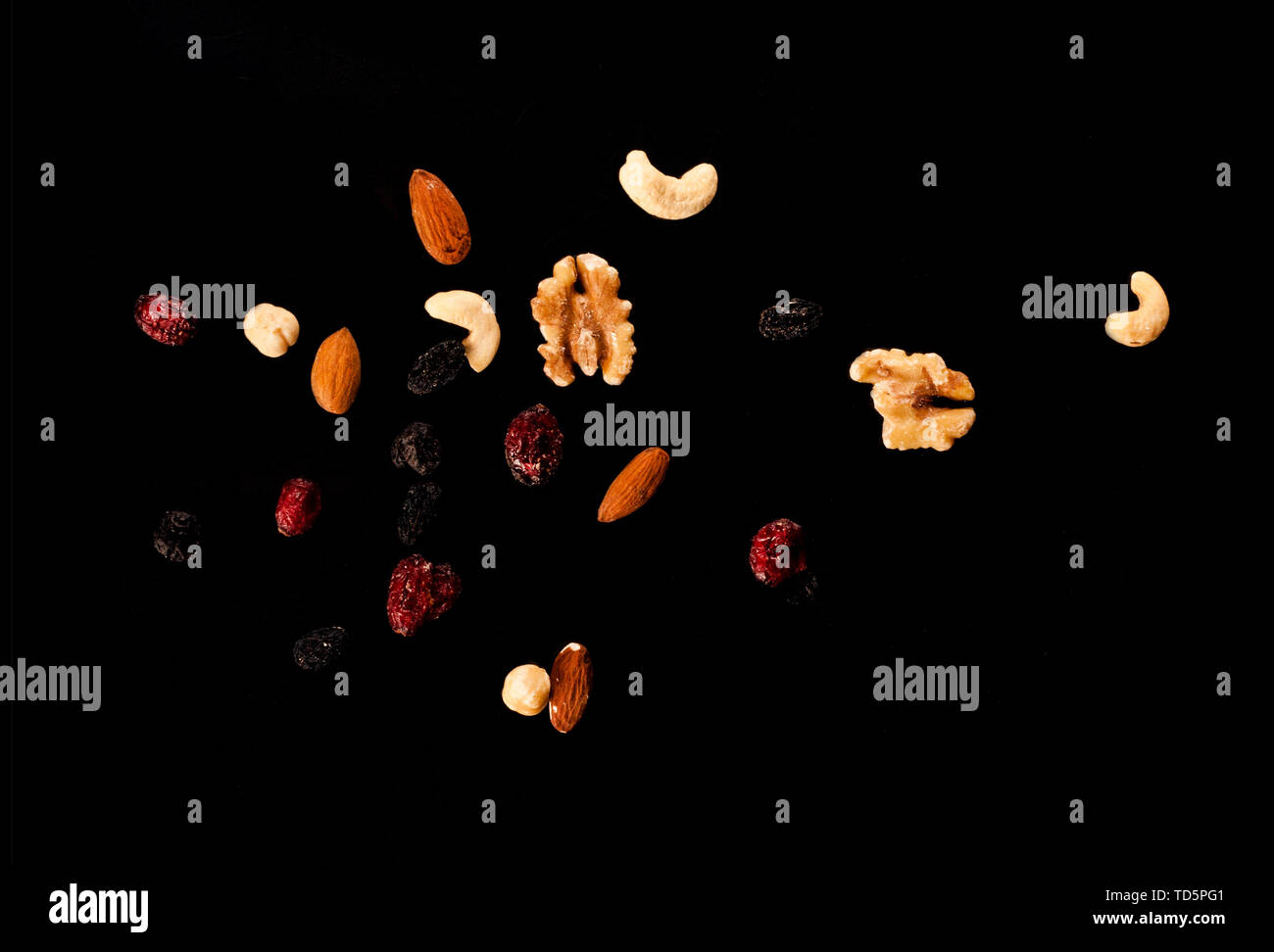 Nuts black background Stock Photo - Alamy