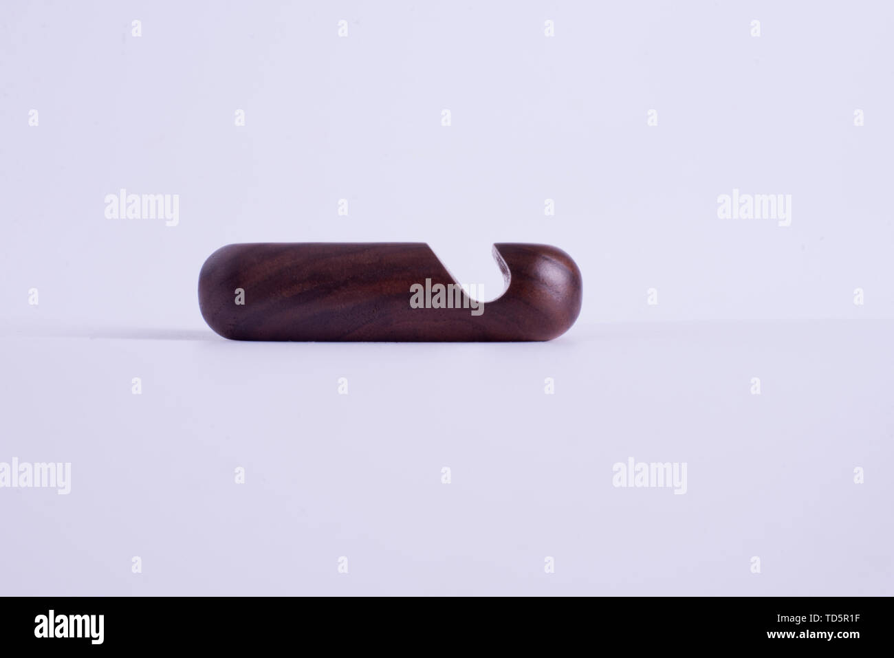 Solid wood mobile phone base on white background Stock Photo - Alamy
